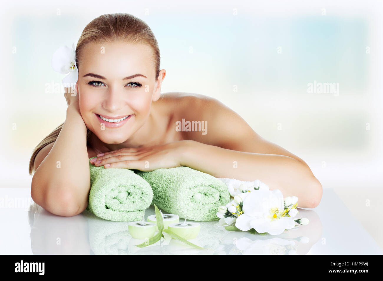 Portrait Of A Beautiful Smiling Woman Lying Down On Massage Table