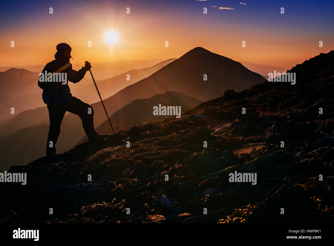 tourist in the mountains at sunset Stock Photo - Alamy