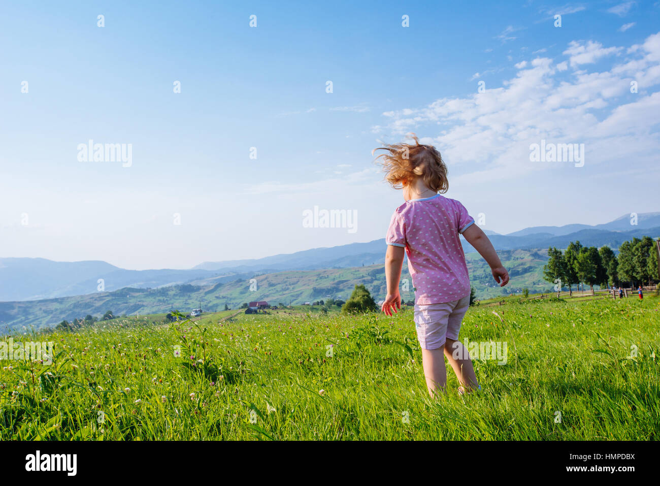 Little toddler girl running in a beautiful field Stock Photo - Alamy
