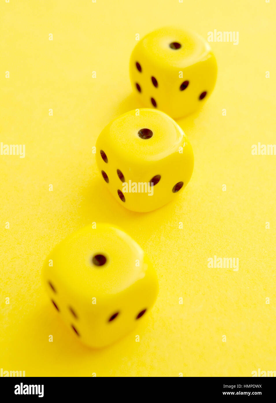 Three yellow dice Stock Photo - Alamy