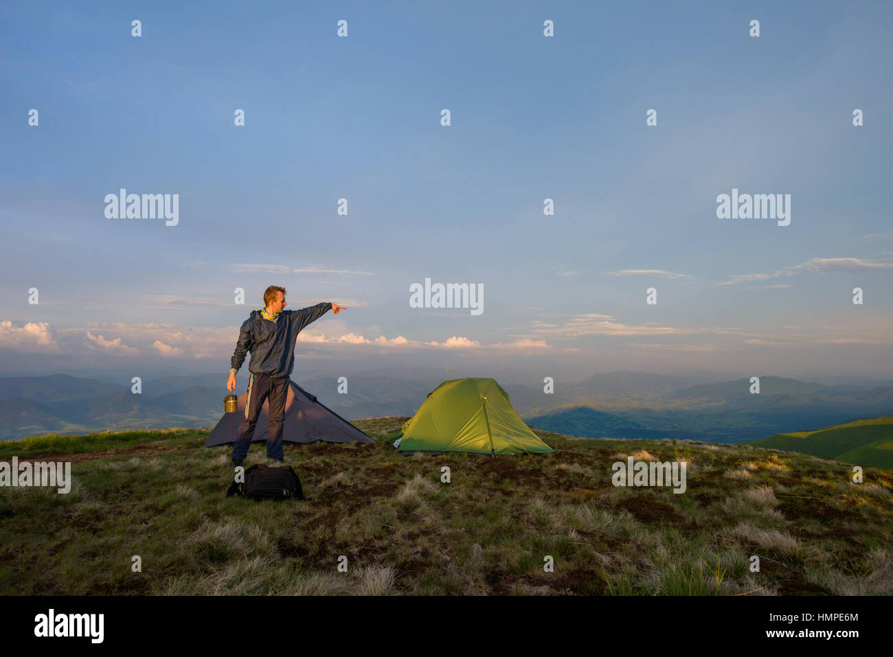 Green Camping tent and man Stock Photo - Alamy