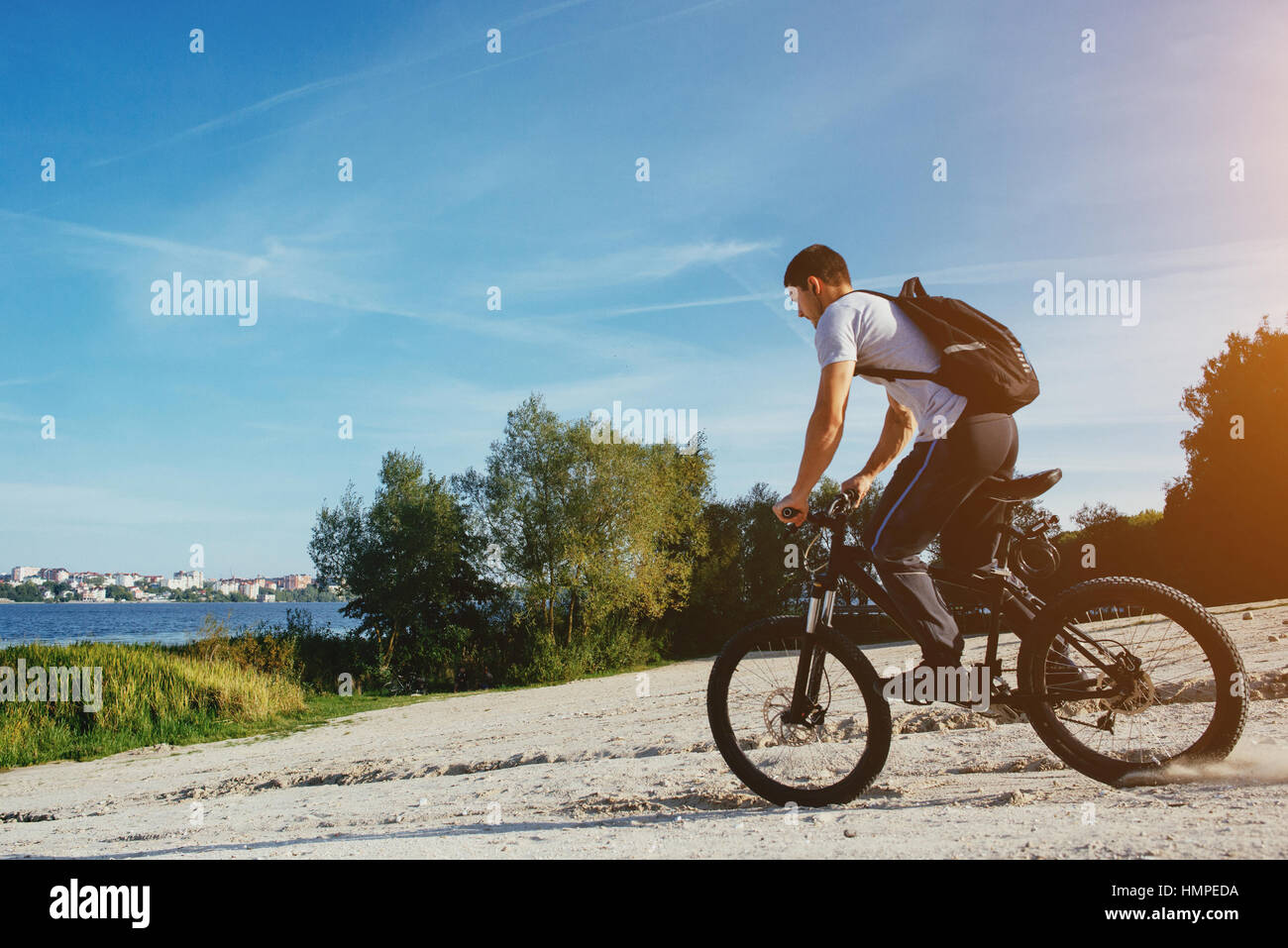 Cyclist riding a bicycle Stock Photo - Alamy