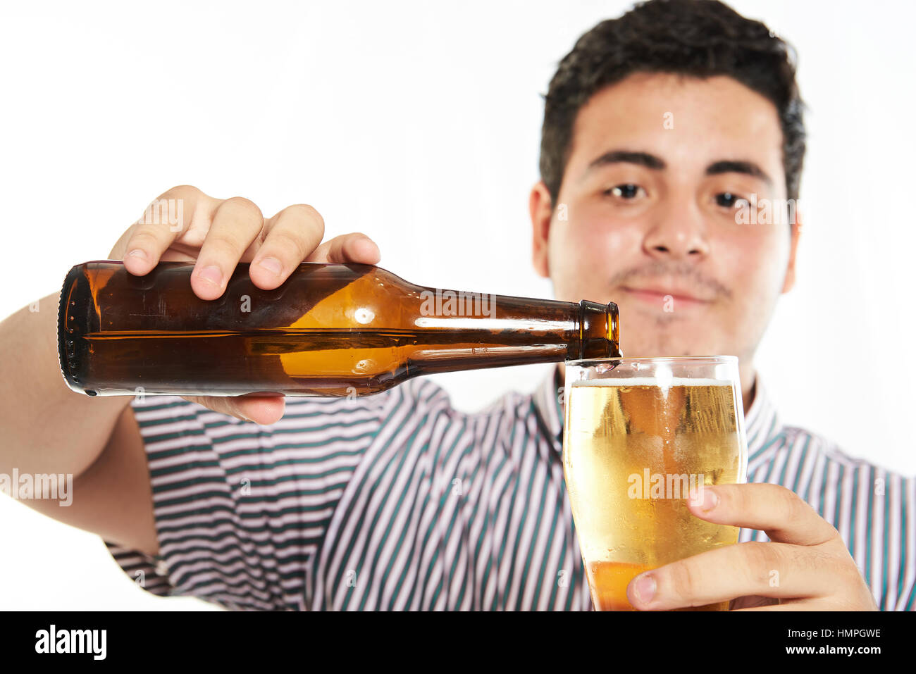 man pouring beer from bottle isolated on white Stock Photo - Alamy