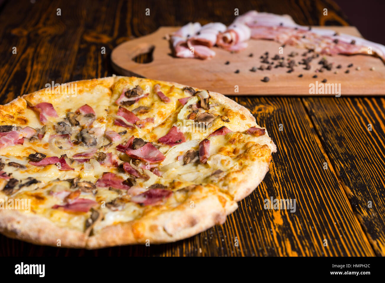 Close up of tasty pizza with variety of toppings and cheese on wooden ...
