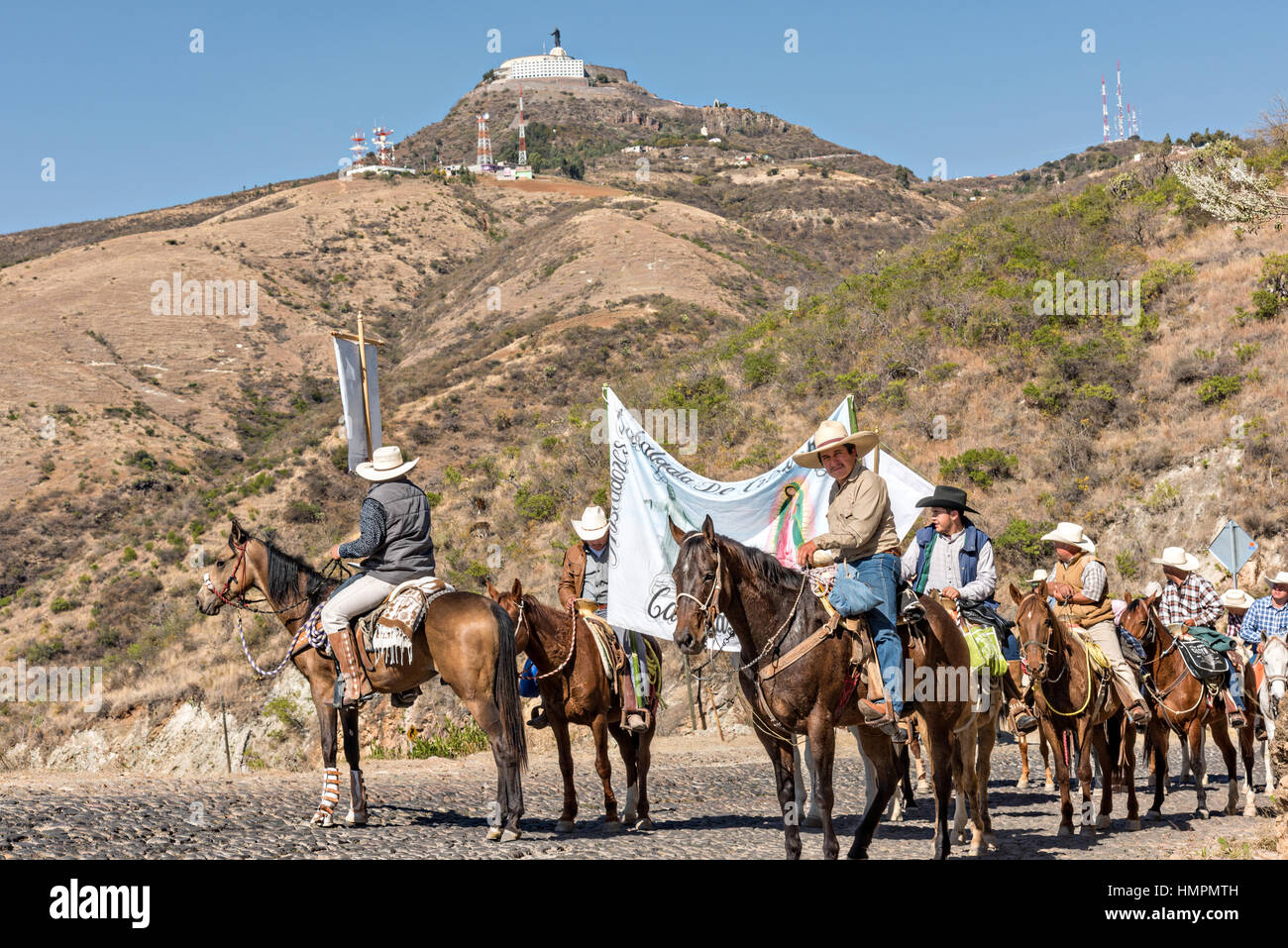 Hundreds of Mexican cowboys snake along the road up Cubilete Mountain ...