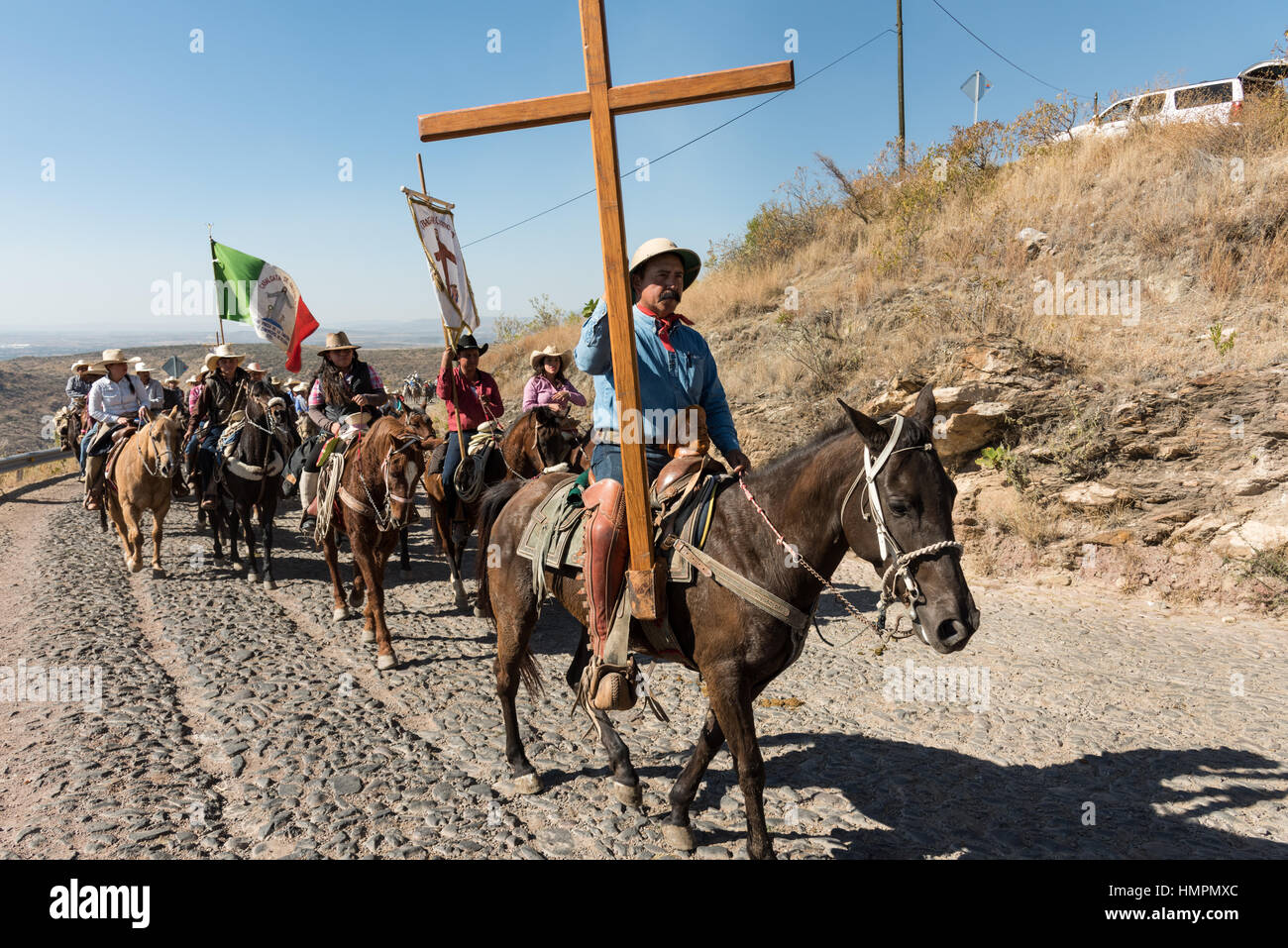 Hundreds of Mexican cowboys snake along the road up Cubilete Mountain ...