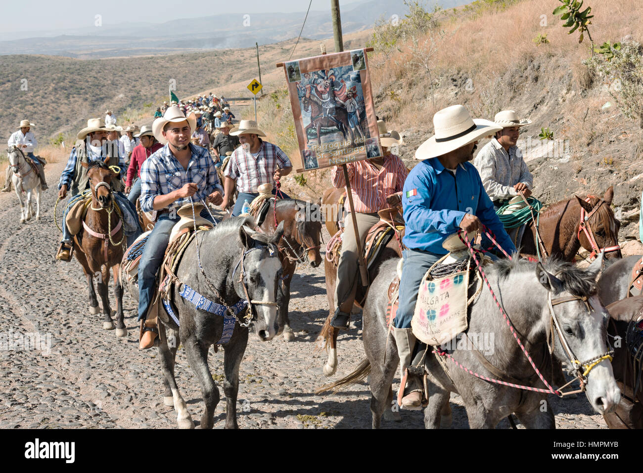 Hundreds of Mexican cowboys snake along the road up Cubilete Mountain ...
