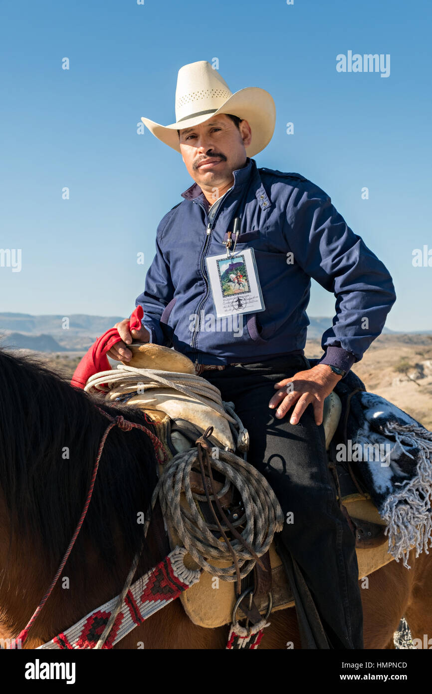 A Mexican cowboy wears a badge signifying his position as a leader of ...