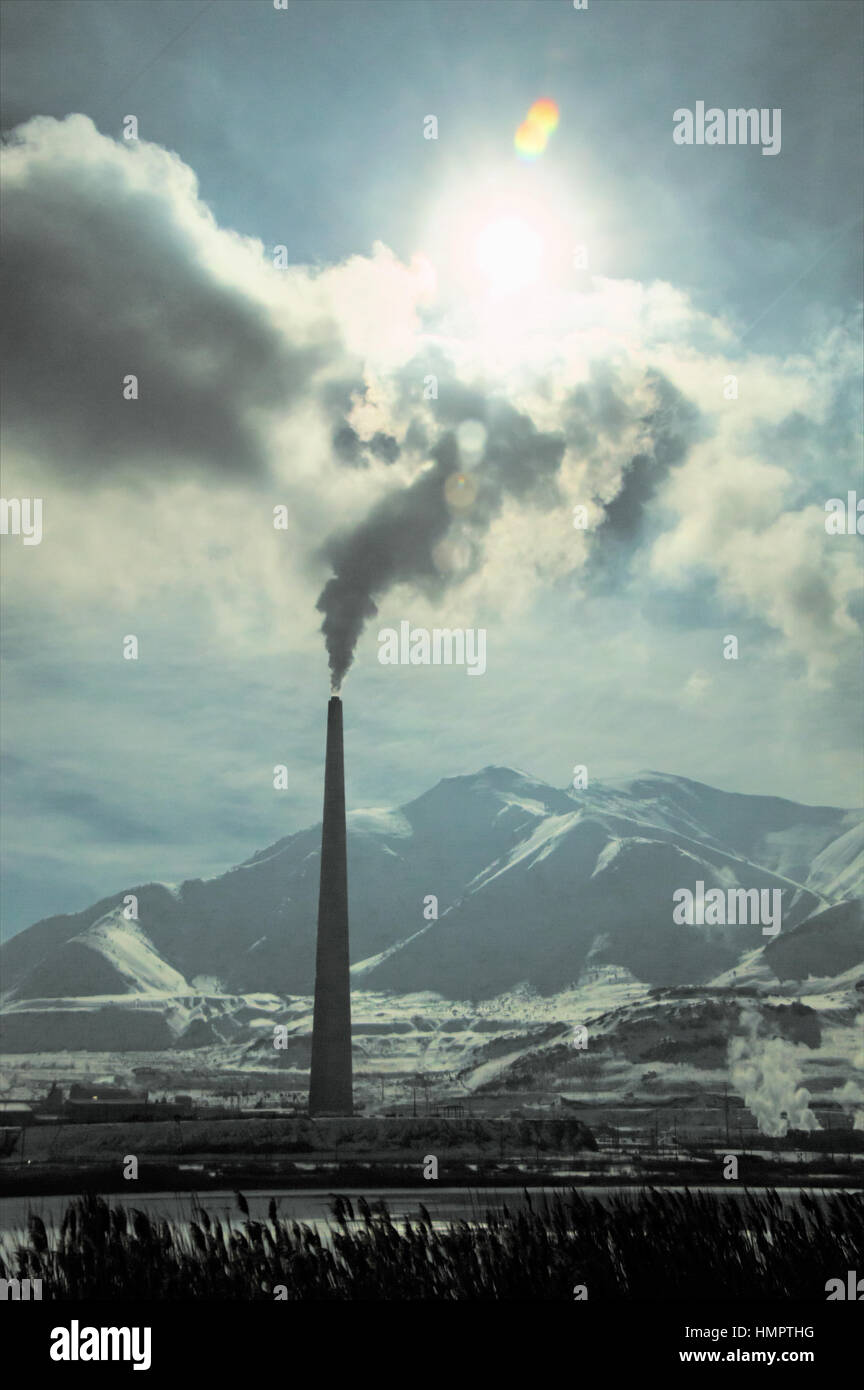 A smoke stack from a copper smelting plant spewing smoke into the pure ...