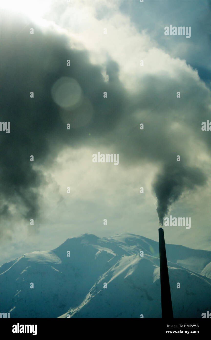 A smoke stack from a copper smelting plant spewing smoke into the pure ...