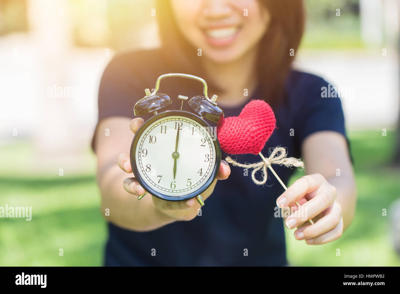 love and time, happy woman hold clock and red heart Stock Photo - Alamy