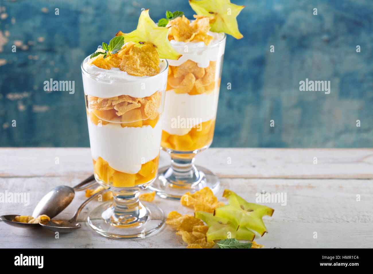 Mango and cereal yogurt parfait in tall glasses Stock Photo - Alamy