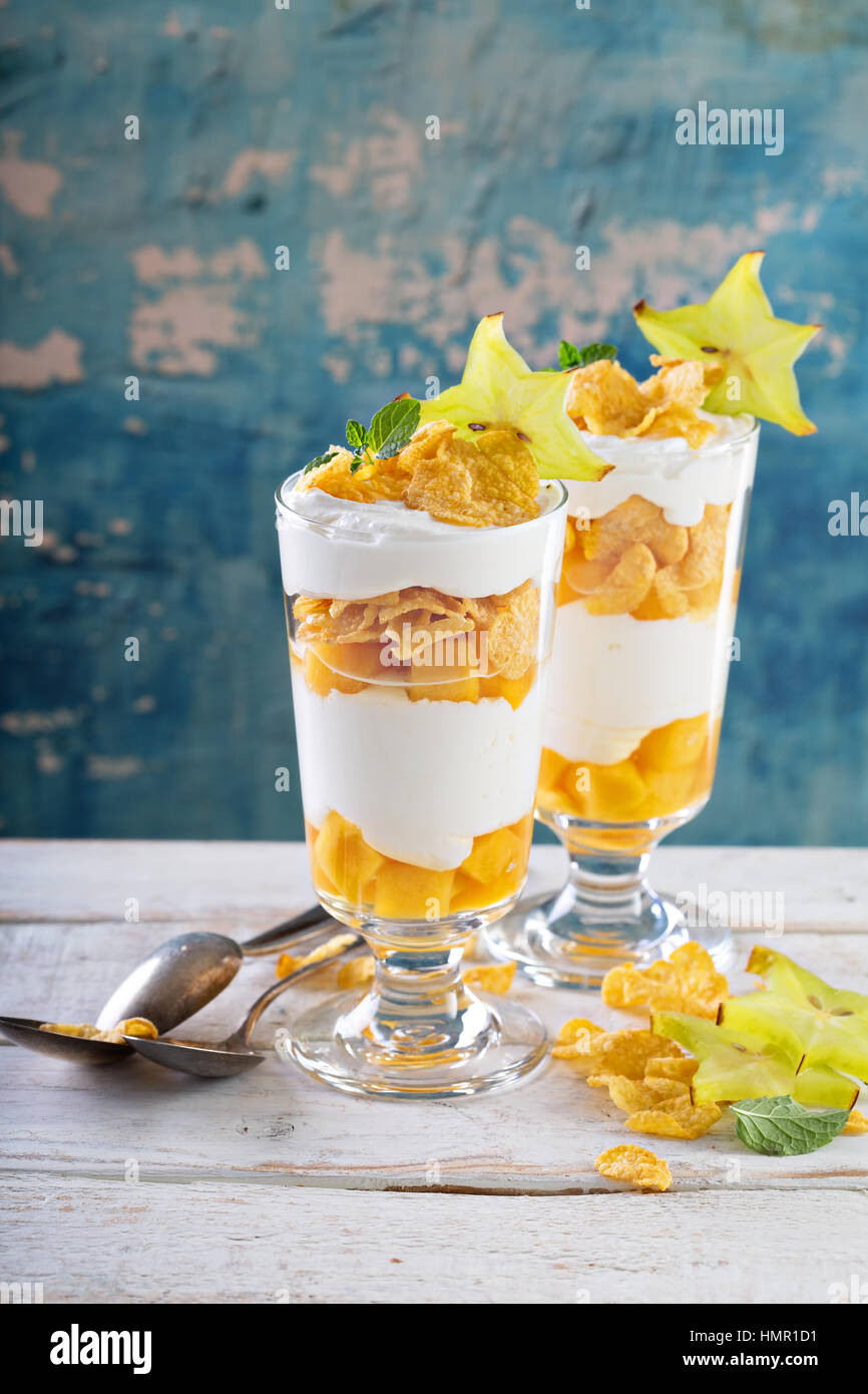 Mango and cereal yogurt parfait in tall glasses Stock Photo - Alamy