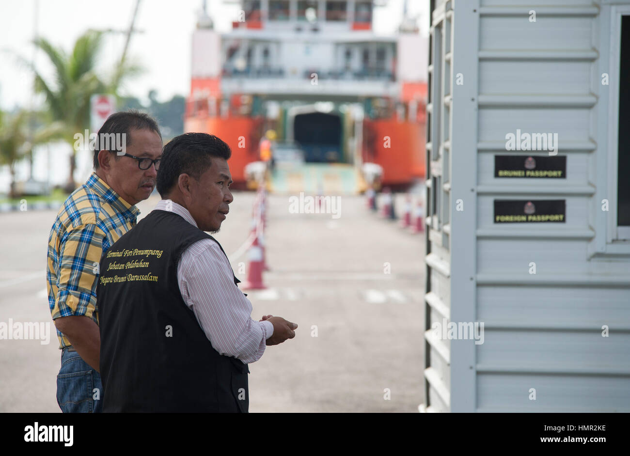 The harbour master talks to a traveller during the immigration process ...
