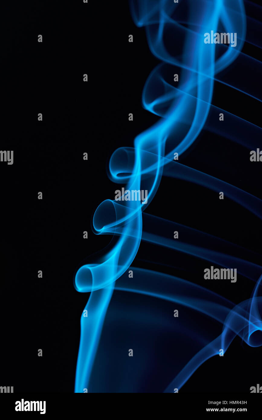 close up of blue curly smoke lines on black background Stock Photo - Alamy