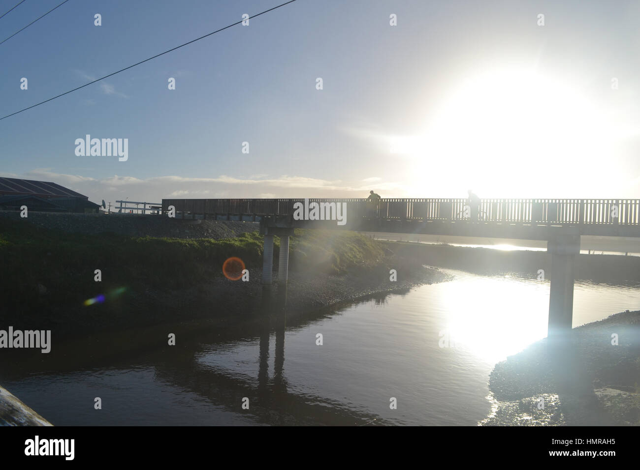 Sun through a bridge Stock Photo - Alamy