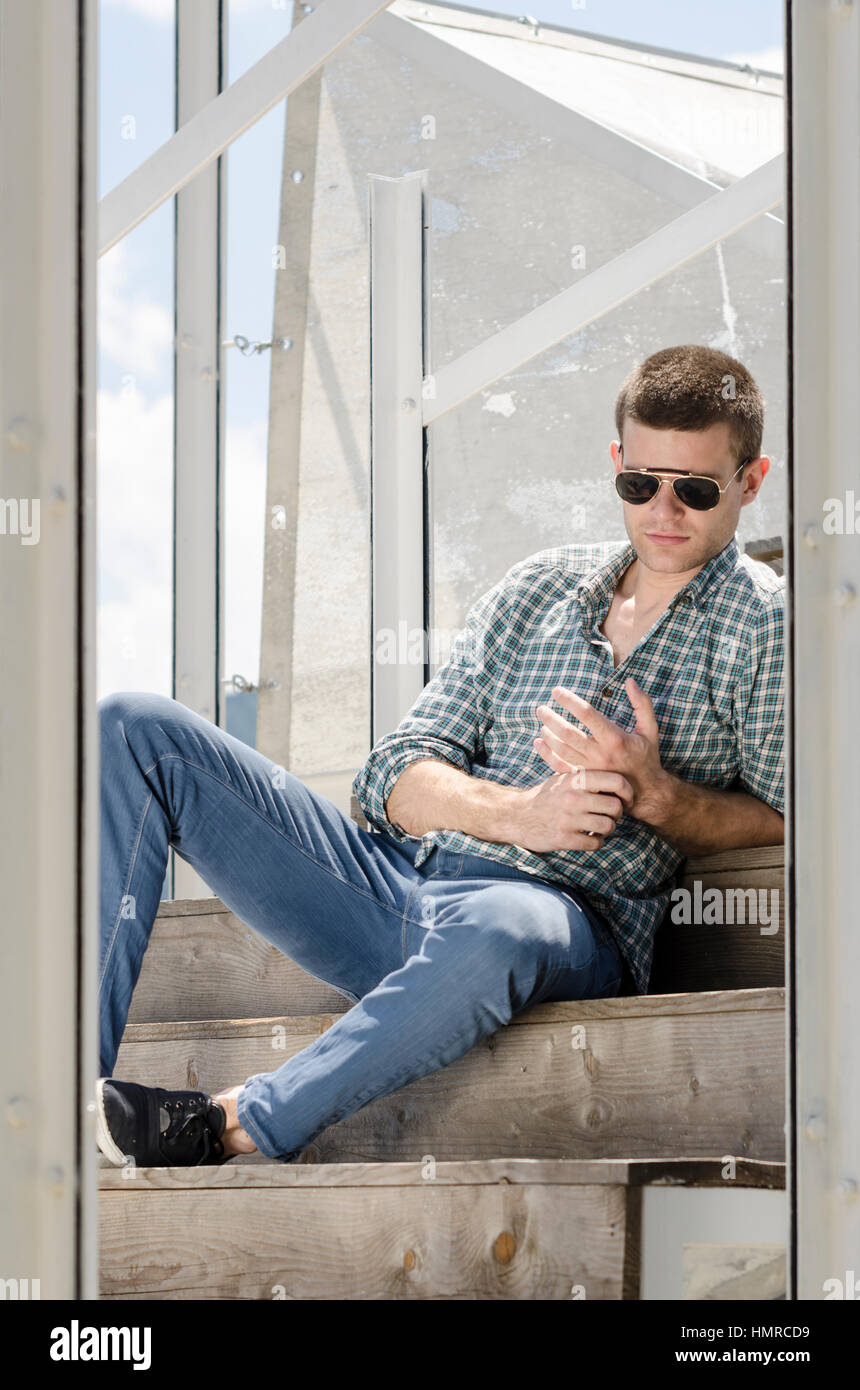 Pensive man sitting on stairs Stock Photo - Alamy