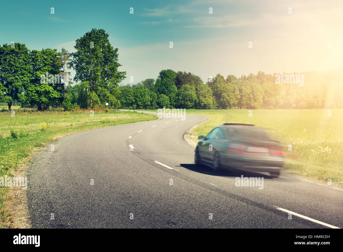 Car on asphalt road in beautiful spring day Stock Photo - Alamy
