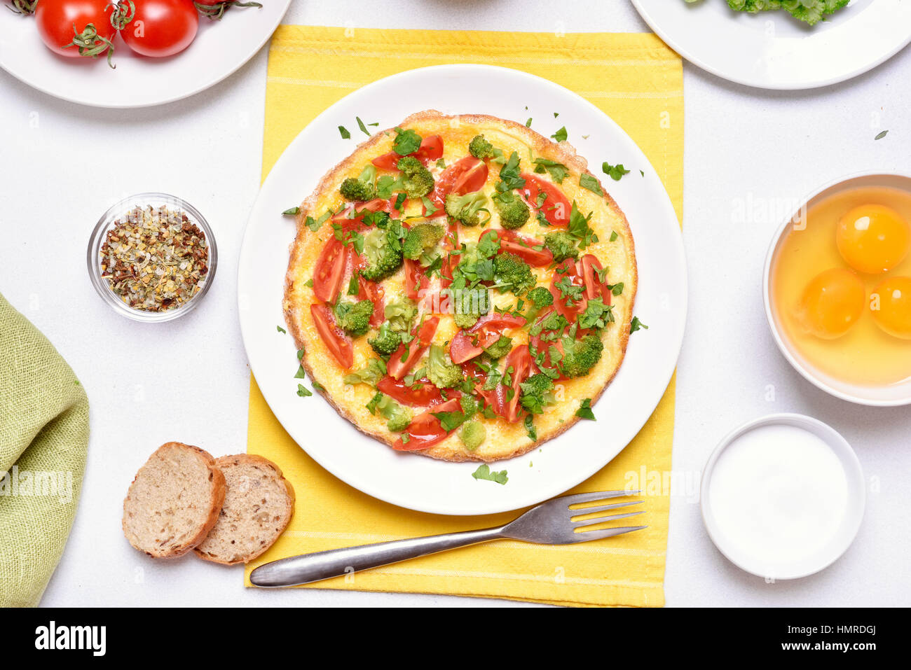 Breakfast, omelet, fried eggs with vegetables on plate, top view Stock ...