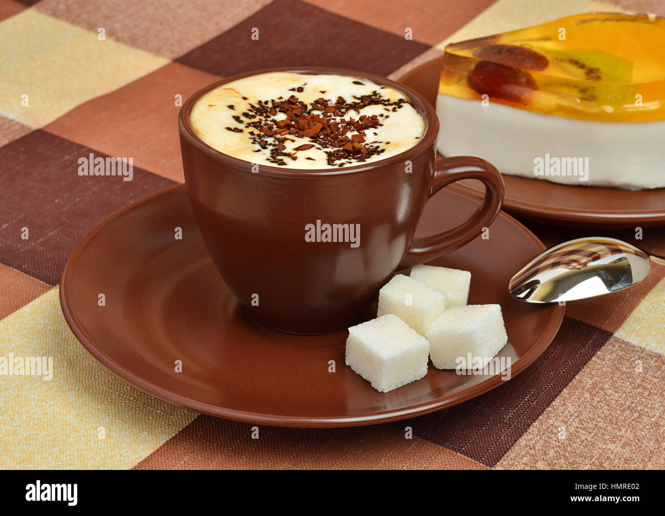 The brown cup of coffee and the pana cotta on the plate Stock Photo - Alamy