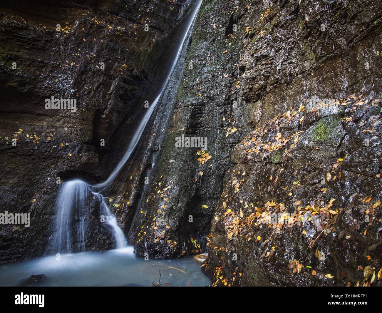 Small waterfall on volcanic black rock bed Stock Photo - Alamy