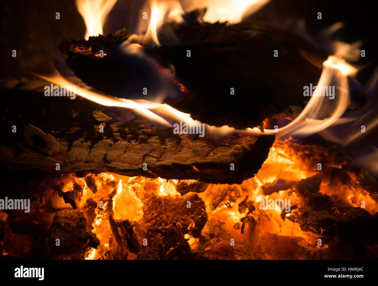 Closeup of wood logs burning and embers in fireplace or campfire Stock ...