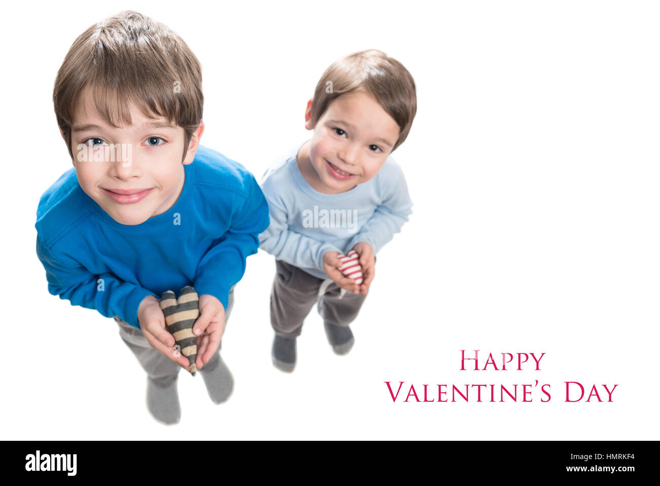 Two brothers holding heart in hands. Isolated on a white background ...