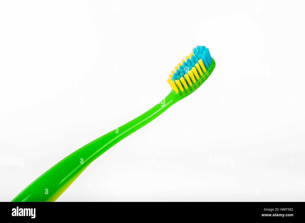 New green toothbrush. Studio shot isolated on white background Stock ...
