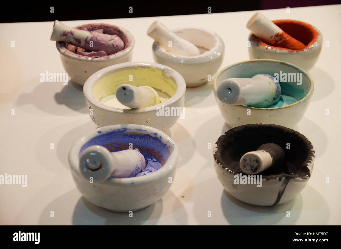 Colorful acrylic powder color in kitchen mortar and pestle or mortar ...