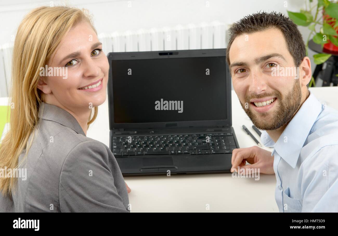 attractive man and beautiful woman business team using laptop computer ...