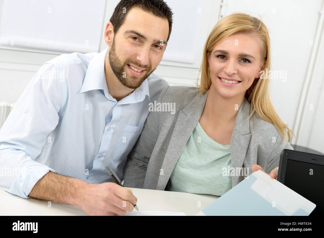 Happy young couple signing property purchase contract Stock Photo - Alamy