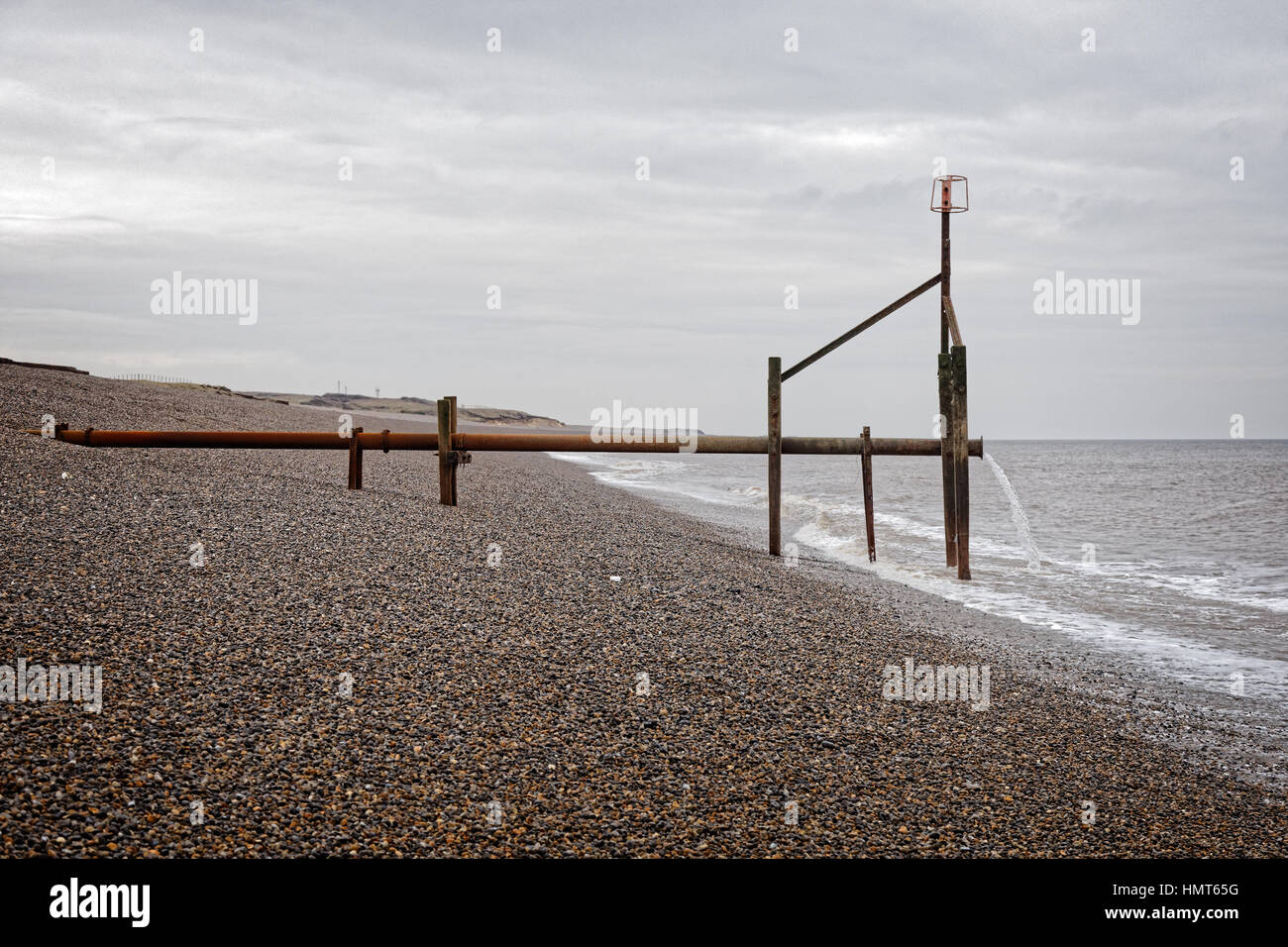 Water Piped Across a Beach Flowing into the Sea Under Dilapidated ...