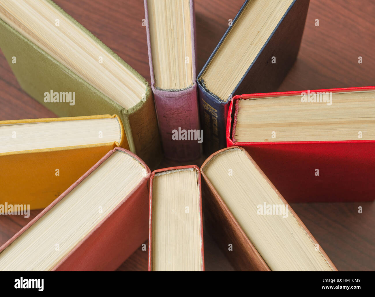 a stack of colorful books in a library or a room Stock Photo - Alamy