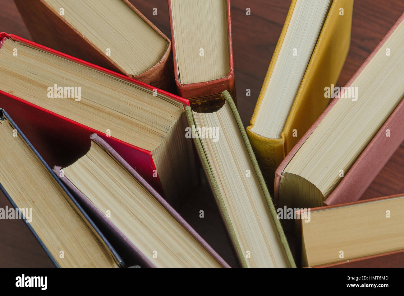 a stack of colorful books in a library or a room Stock Photo - Alamy