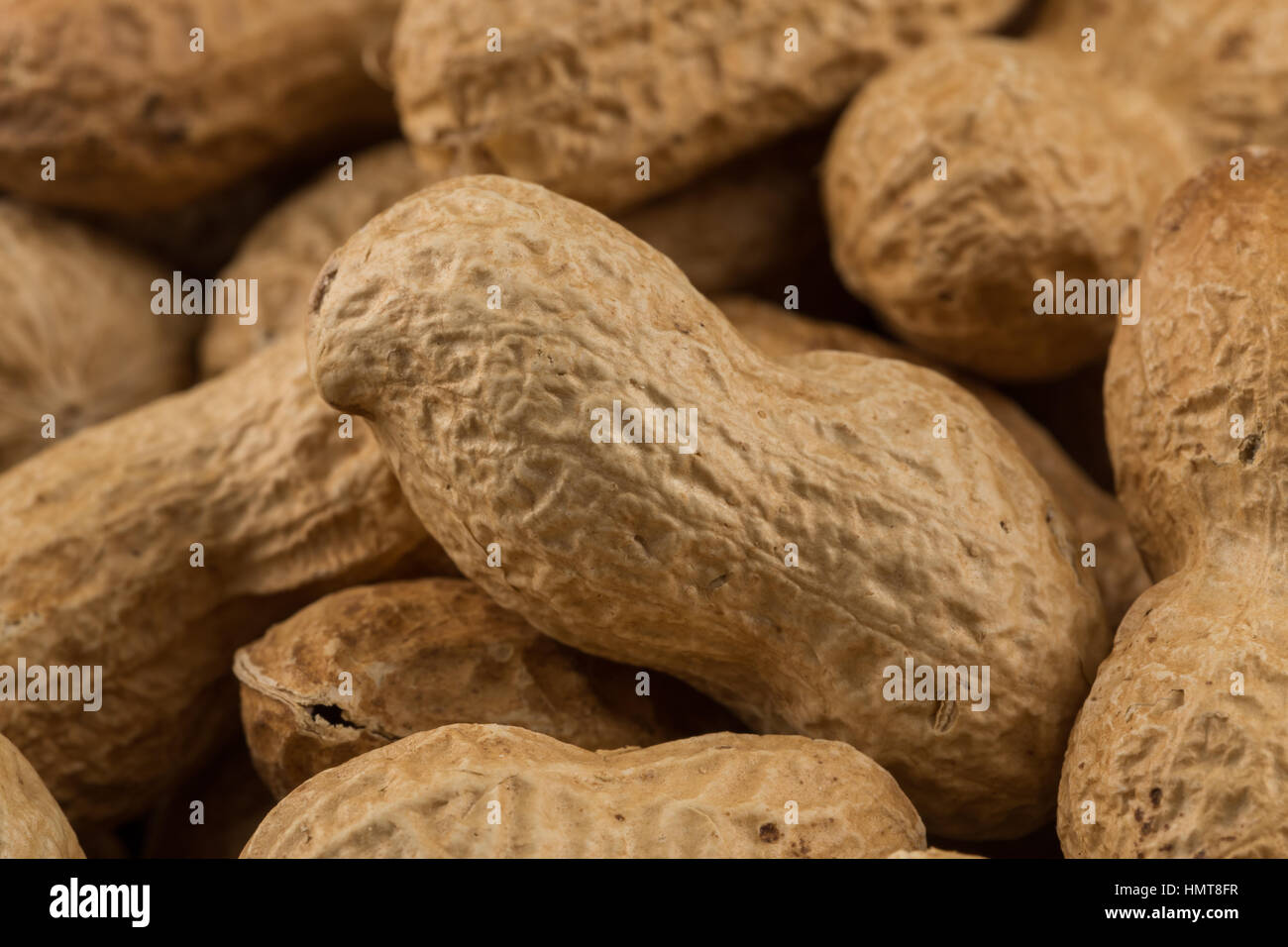 Pile of peanuts shells close up for background Stock Photo - Alamy