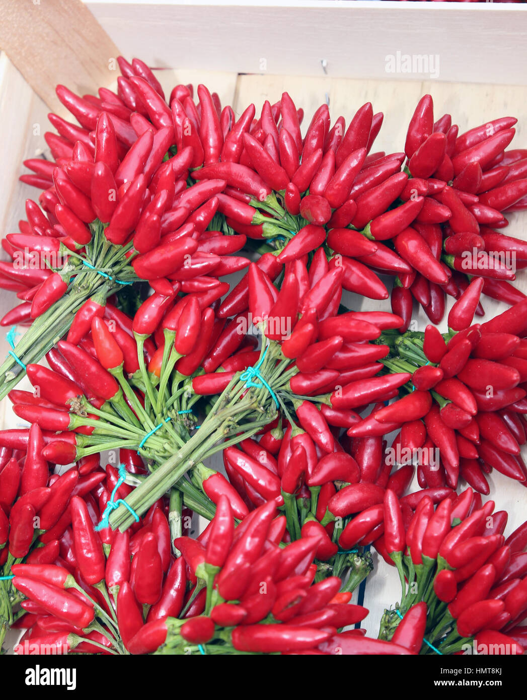 Many bouquets of red hot chillies on sale at the greengrocer Stock ...