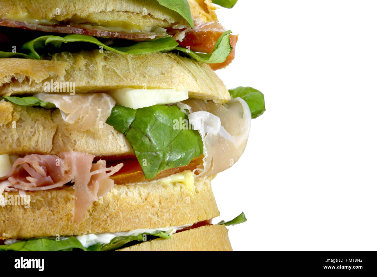 giant sandwich stuffed with many layers of bread with lettuce tomato ...