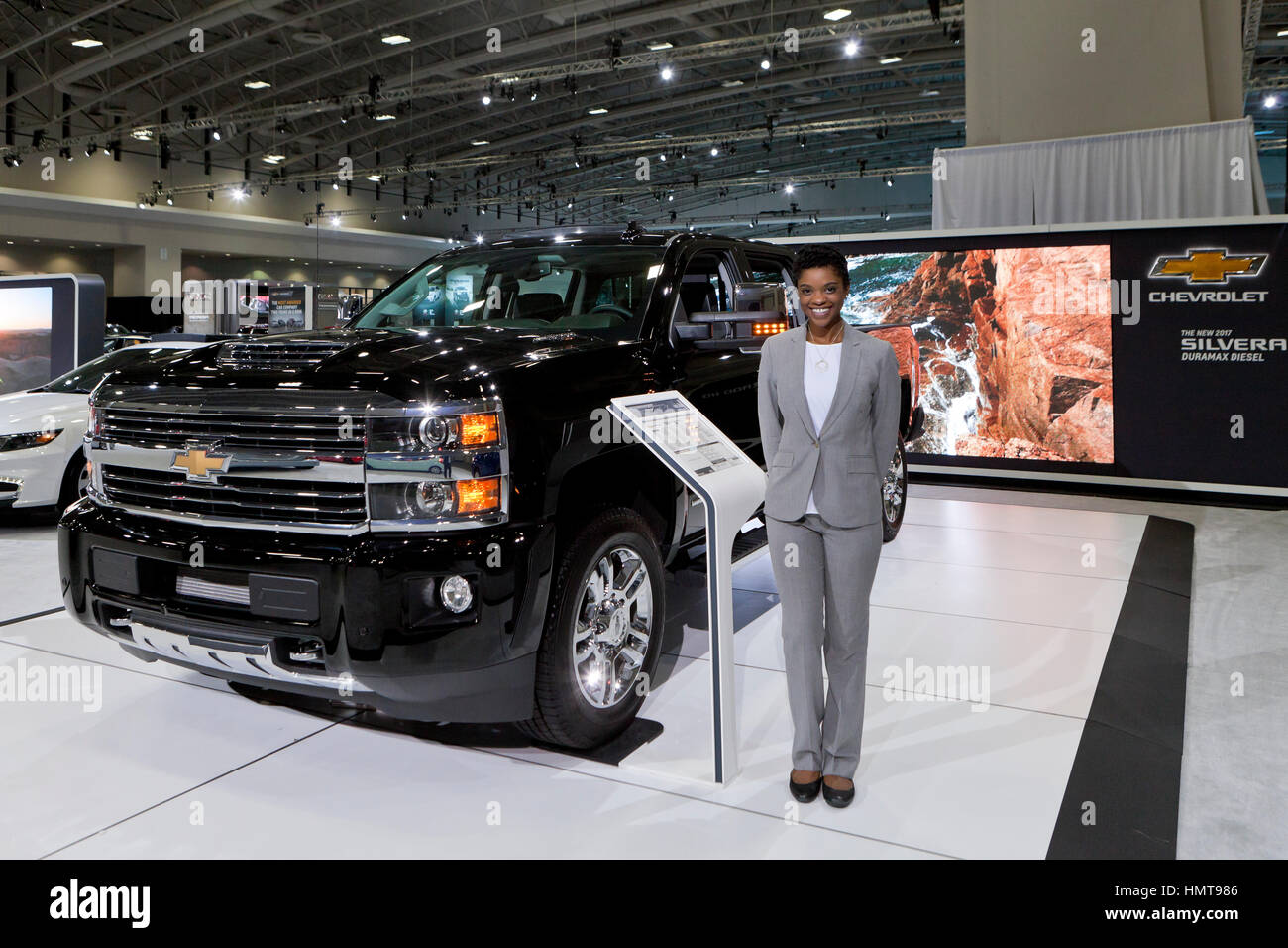 Chevrolet representative standing next to a Chevy Silverado Pickup ...