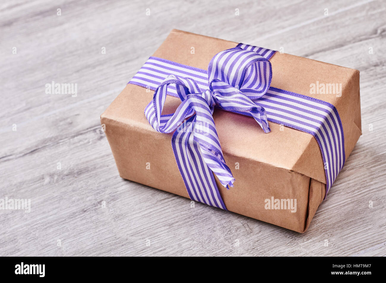 Gift box on wooden backdrop Stock Photo - Alamy