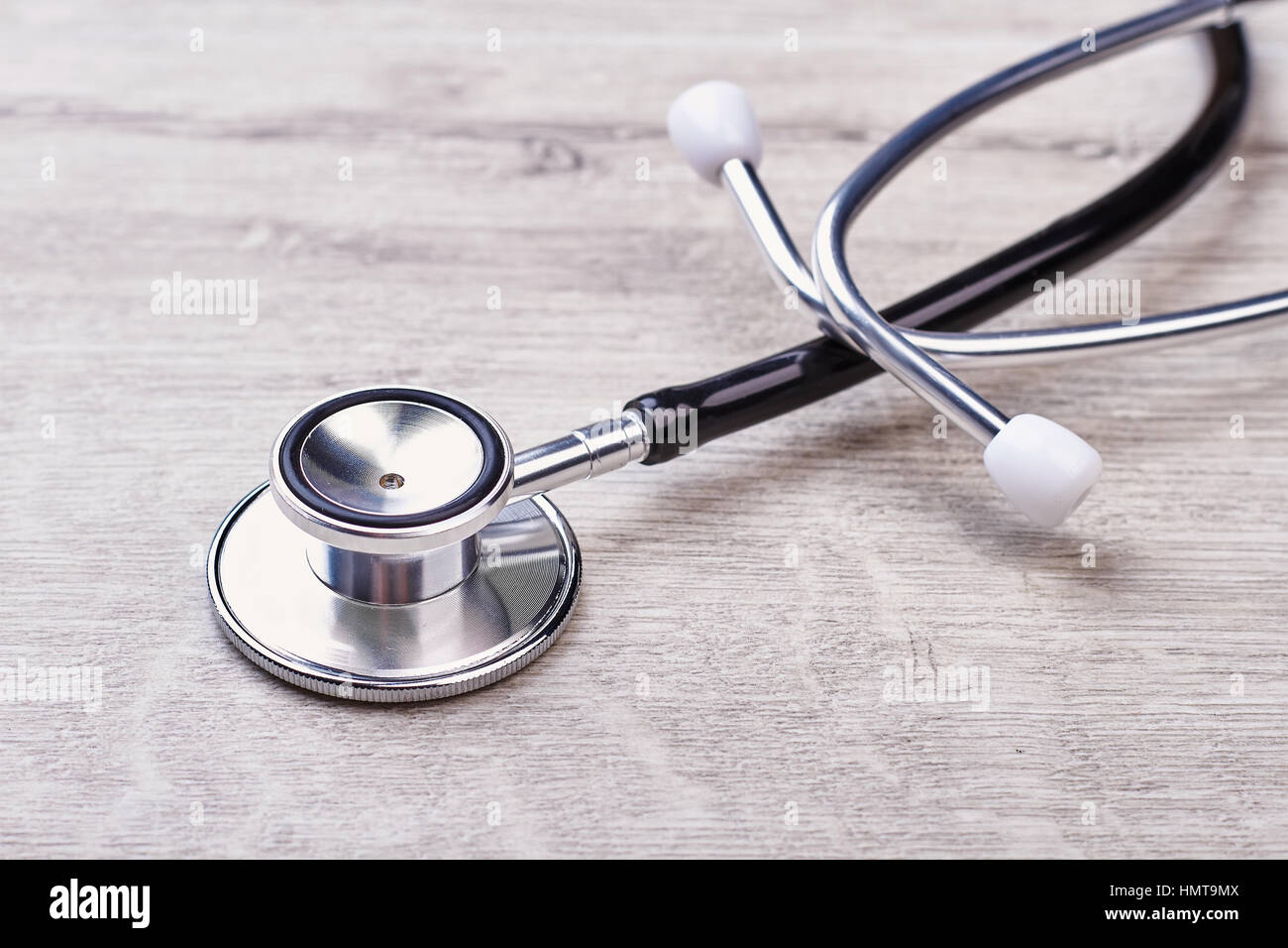 Stethoscope lying on wooden table Stock Photo - Alamy