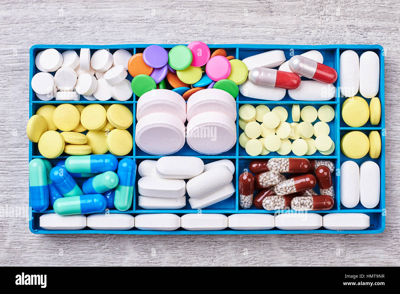Pills and capsules in container Stock Photo - Alamy