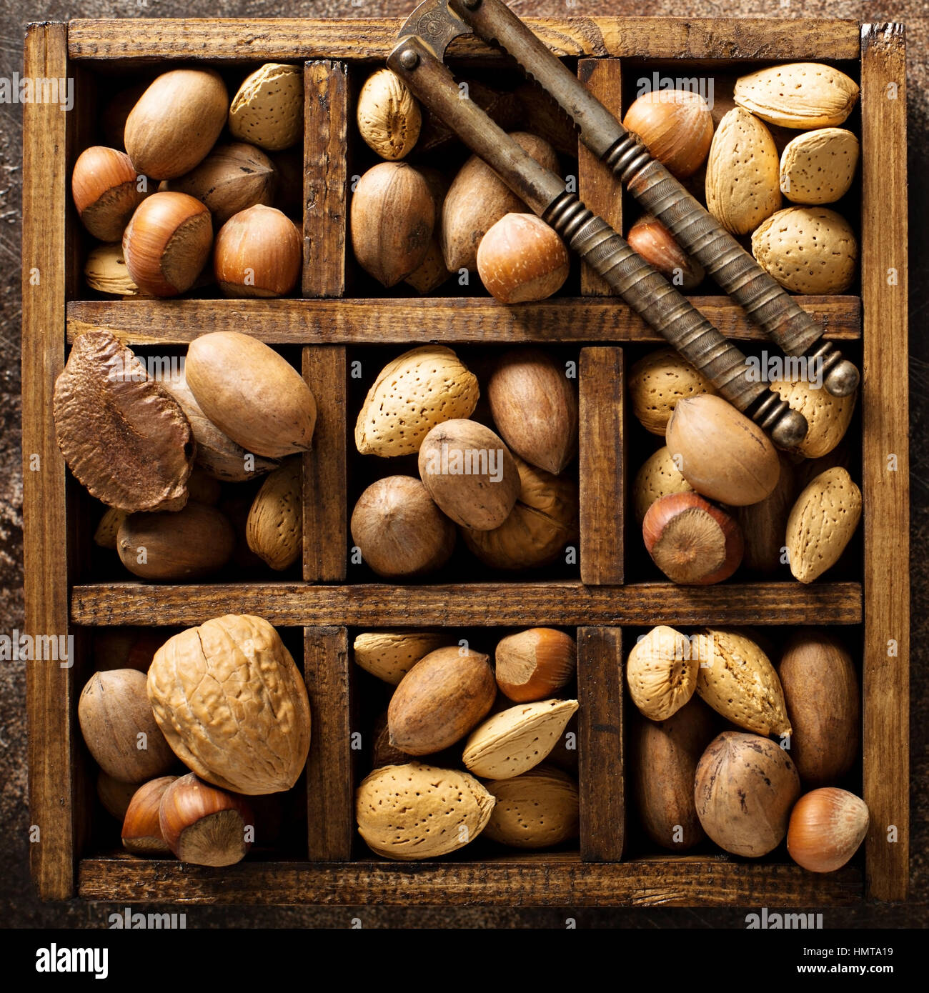 Various nuts in shell in a wooden box Stock Photo - Alamy