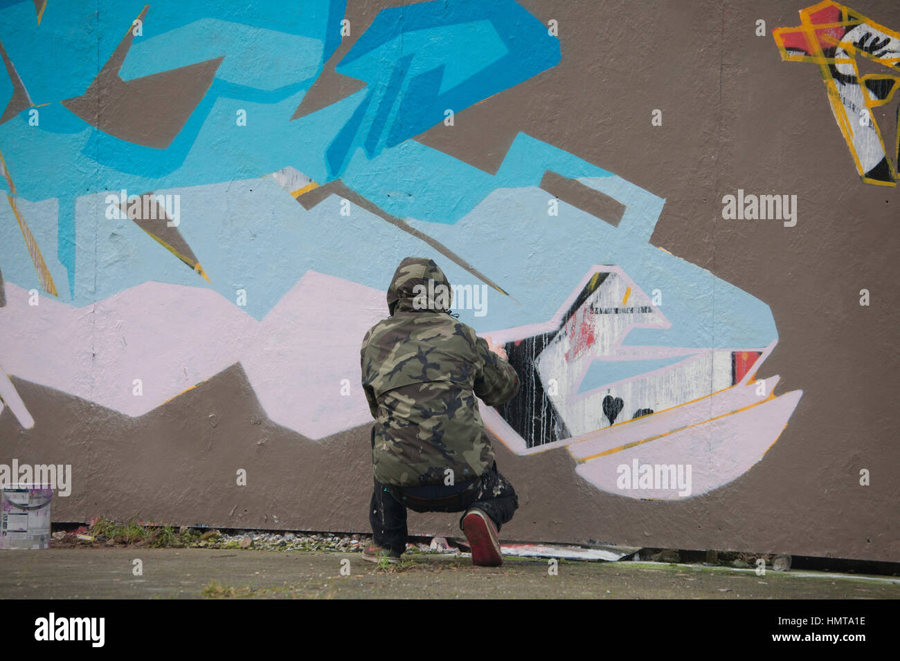 A graffiti artist spraying a wall Stock Photo - Alamy