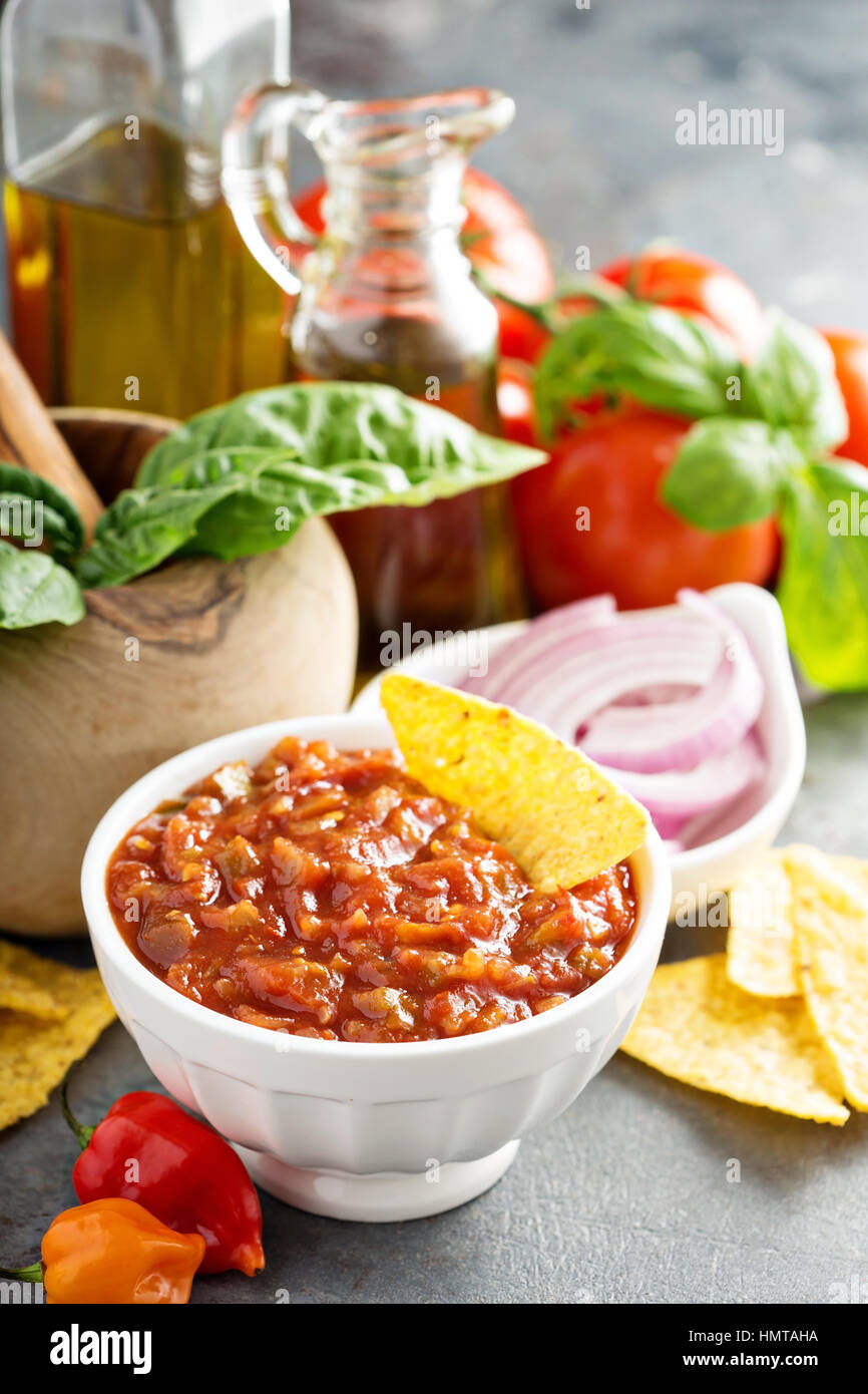 Homemade spicy tomato salsa with vegetables, herbs and olive oil Stock ...