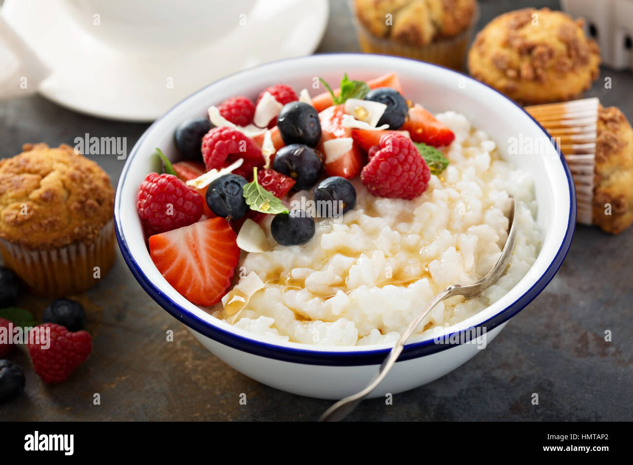 Rice pudding with fresh berries and coconut flakes for breakfast Stock ...