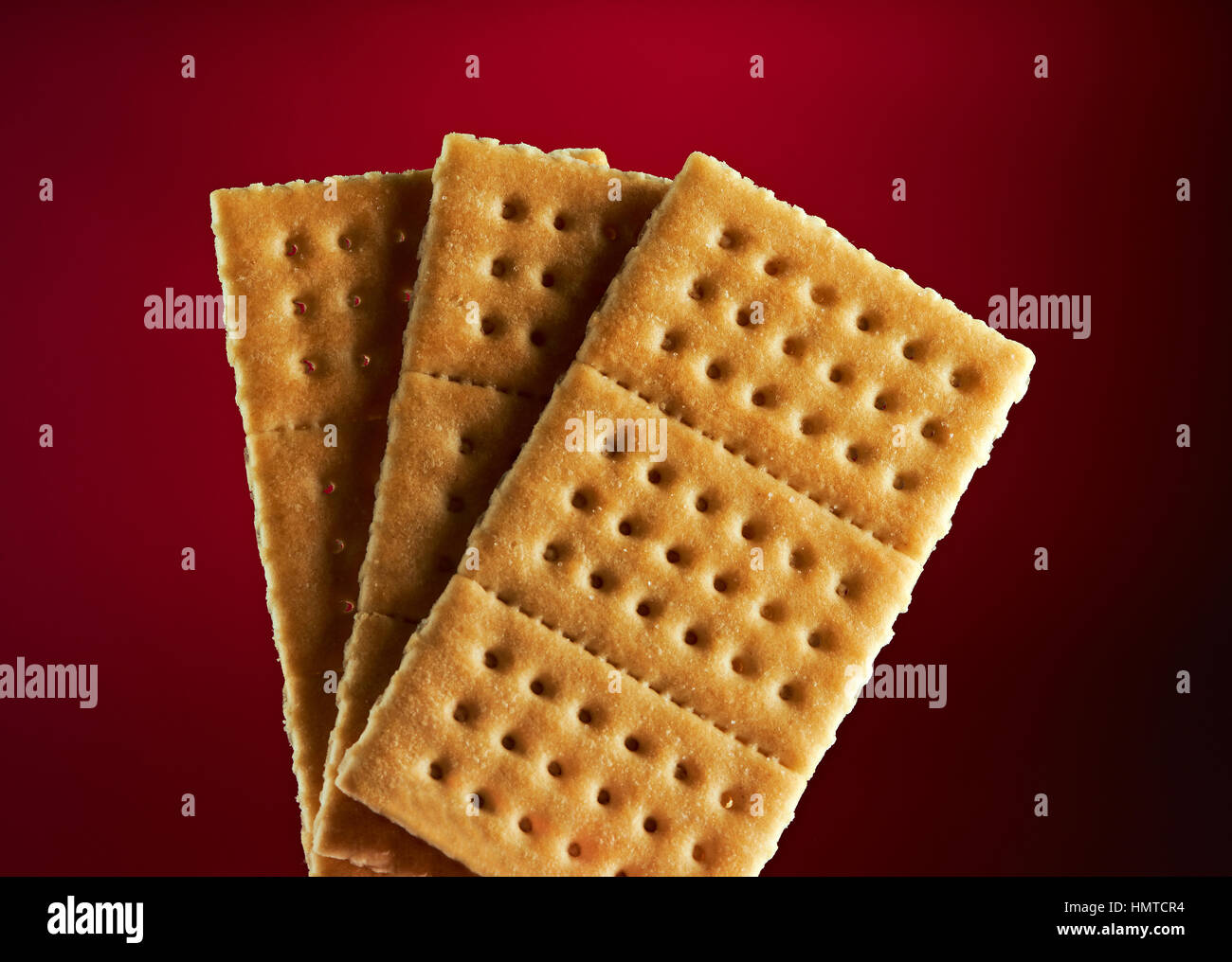 three rectangle crackers isolated on red background Stock Photo - Alamy
