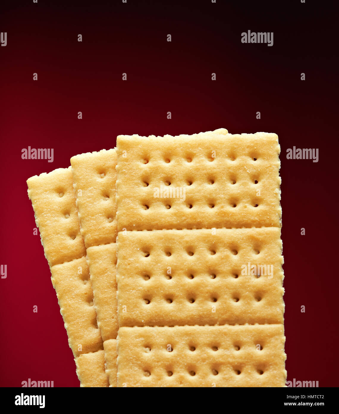 group of crackers isolated on red background Stock Photo - Alamy