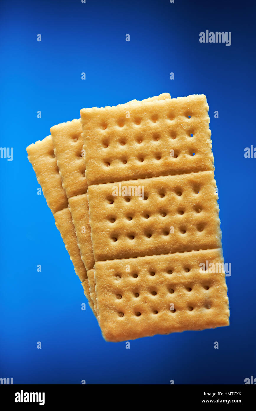 group of sweet cracker on blue background isolated Stock Photo - Alamy