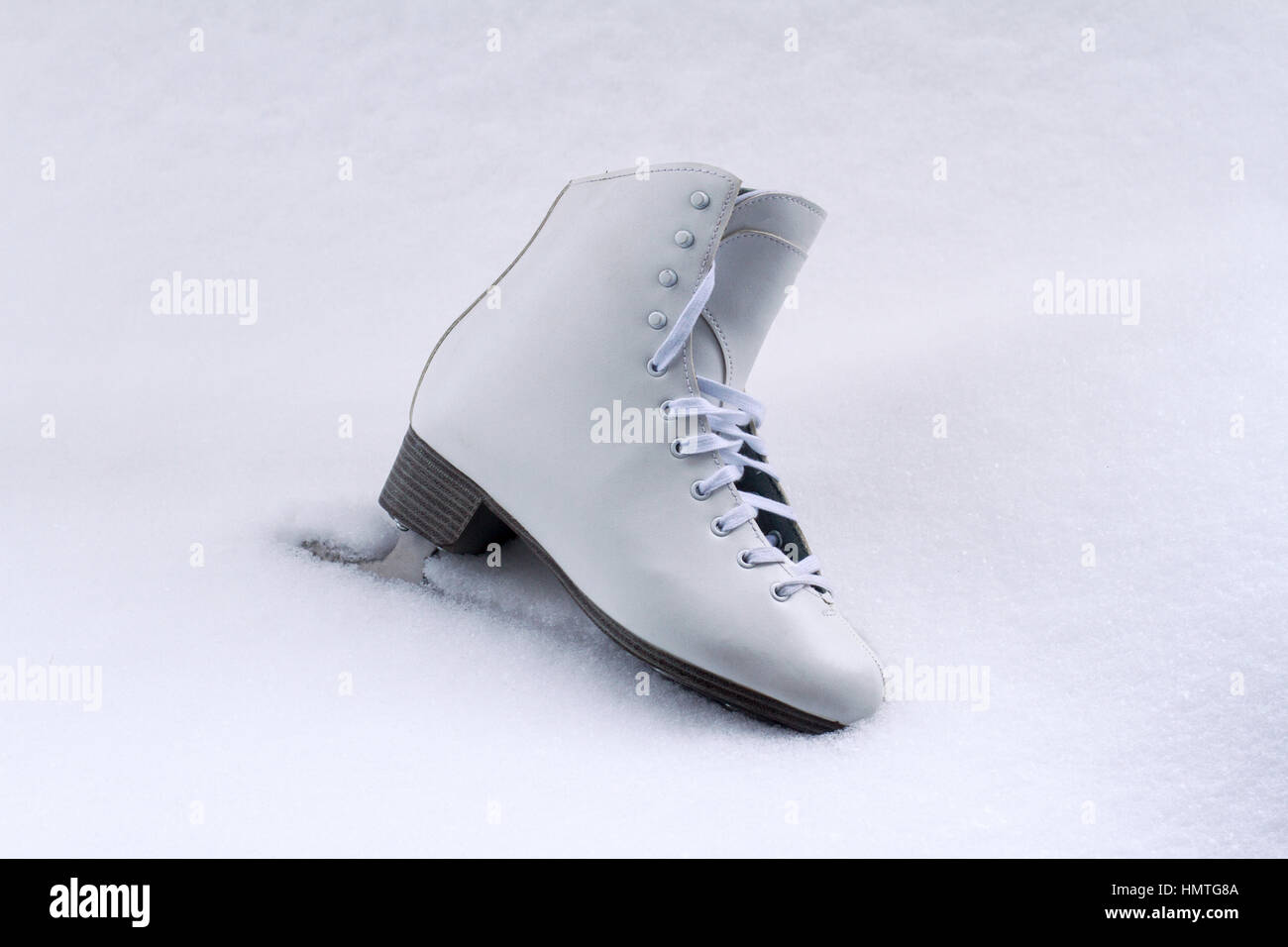 front view of white classical leather iceskate shoe with the metallic ...