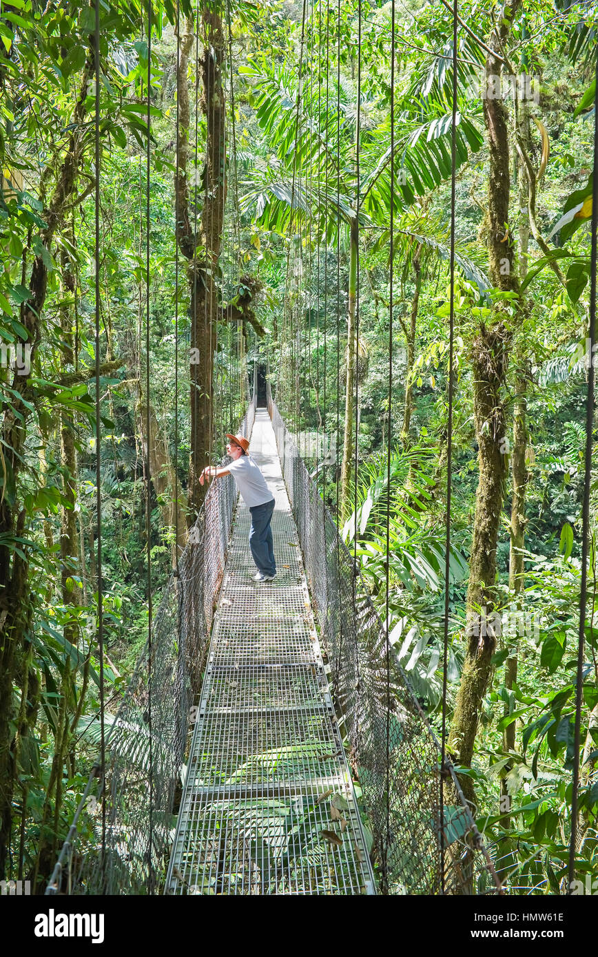 Man standing on hanging bridge hi-res stock photography and images - Alamy